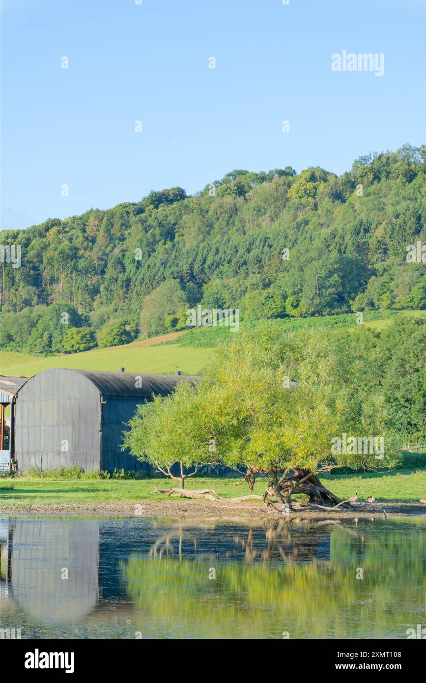 Reflections of farm buildings in Shropshire, UK on a Summer day in ...