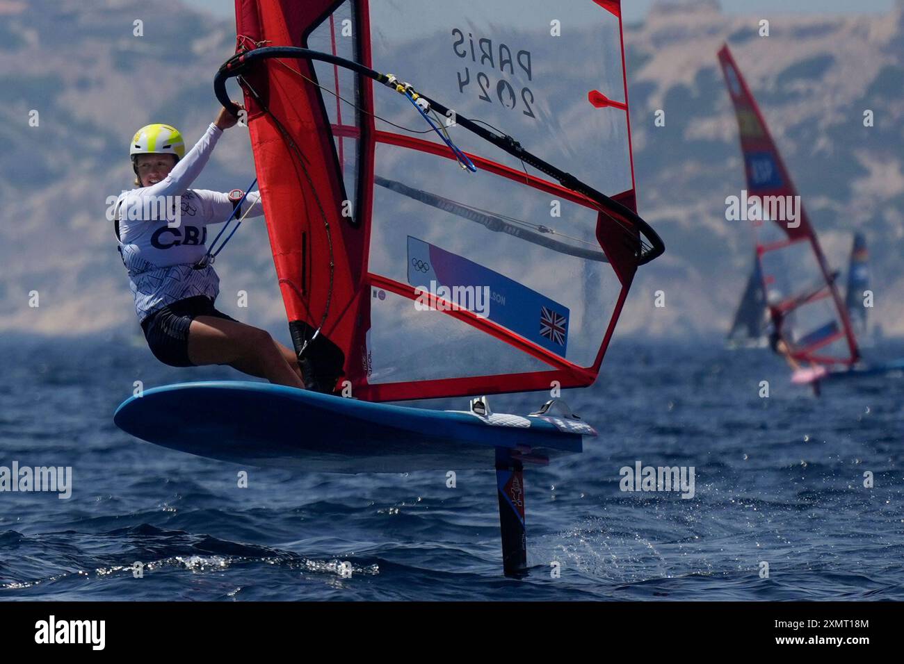 Emma Wilson of Britain sails to cross the finish line to win the first ...