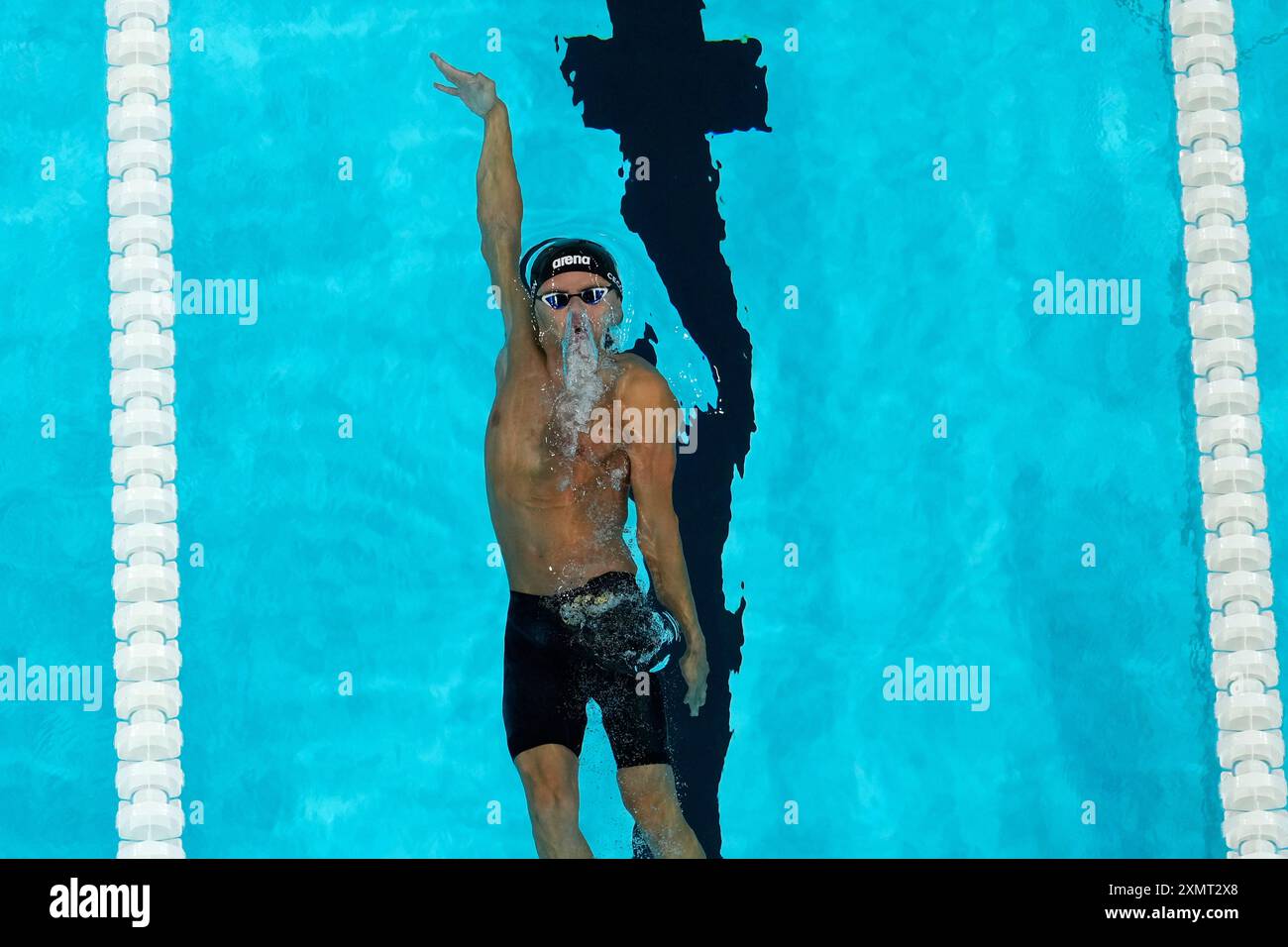 Thomas Ceccon, of Italy, competes in the men's 100-meter backstroke ...