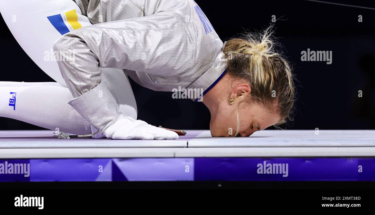 KHARLAN Olga of Ukraine kisses the podium pist after winning a bronze ...