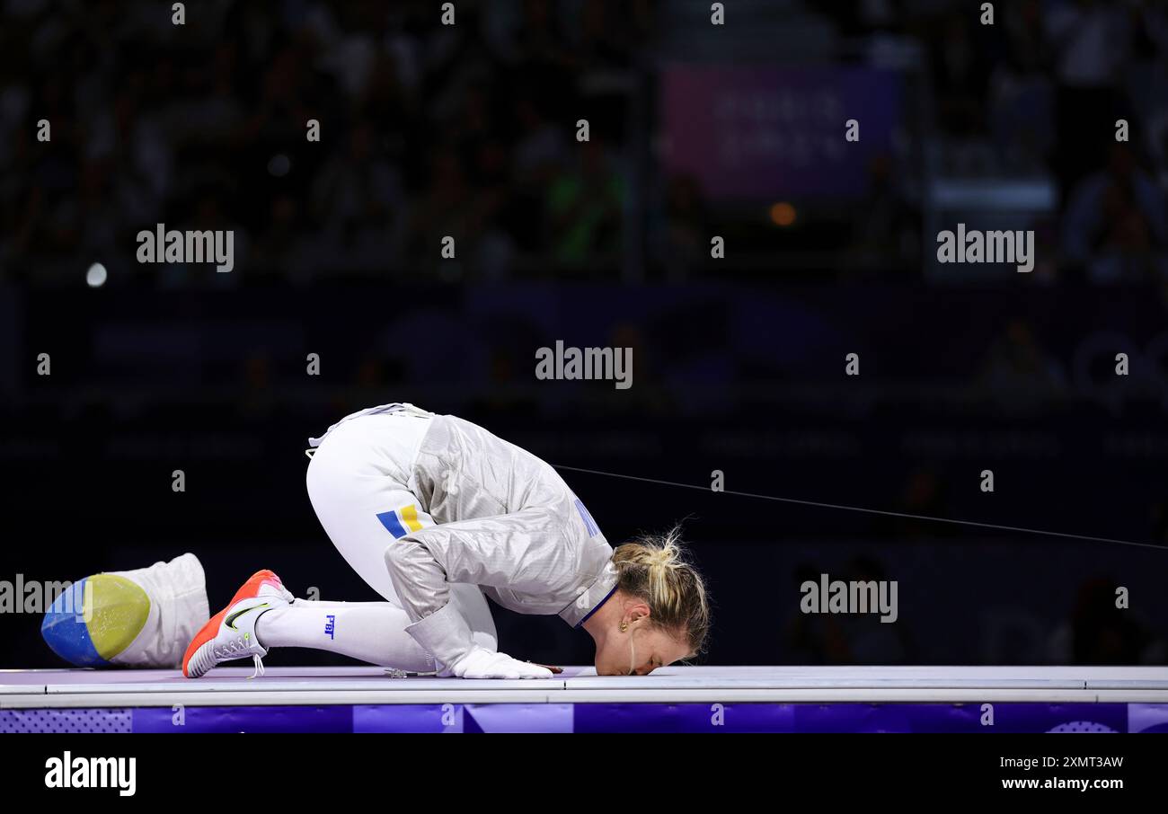 KHARLAN Olga of Ukraine kisses the podium pist after winning a bronze ...