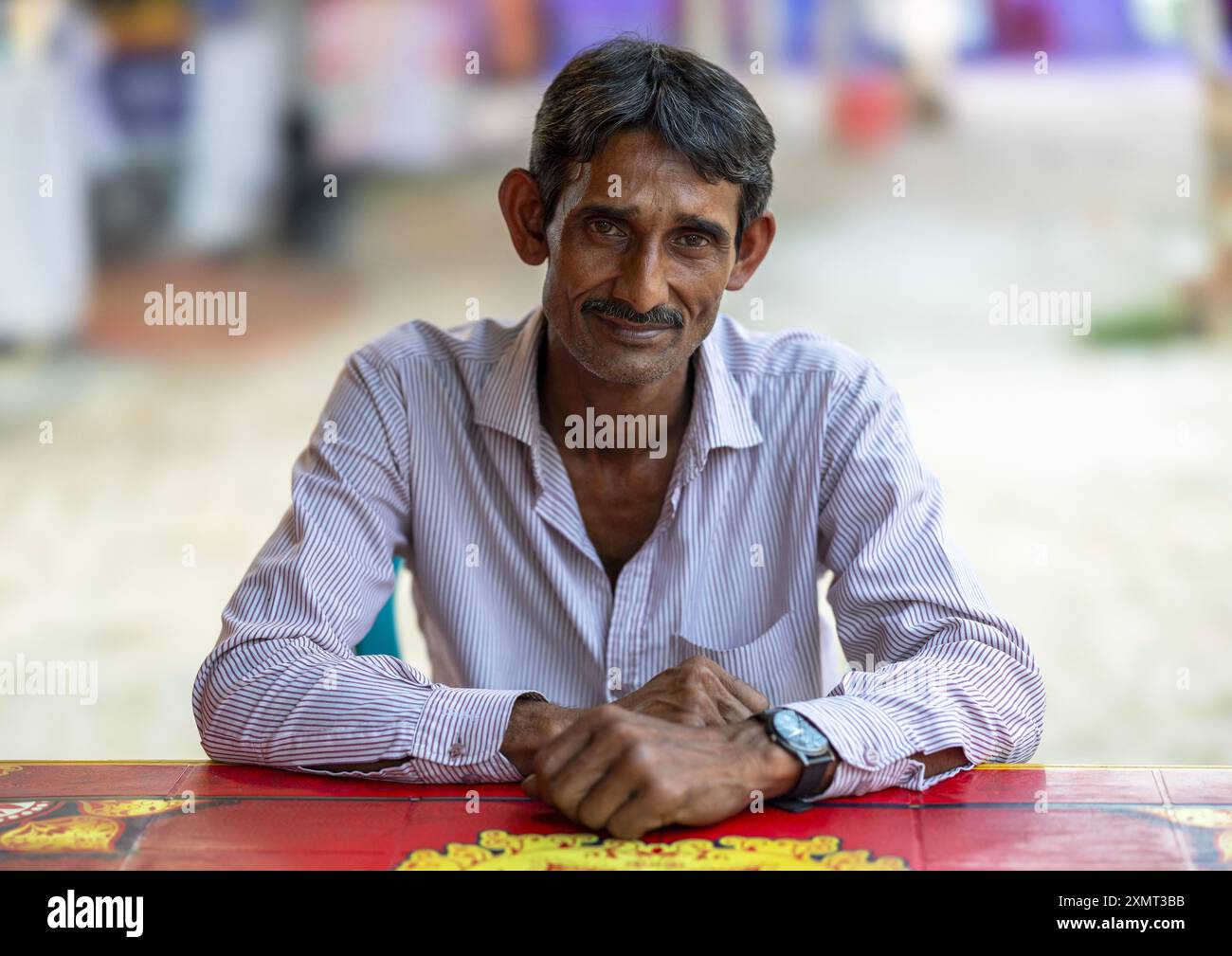 Portrait of a bangladeshi man sit at a table, Khulna Division, Jessore ...