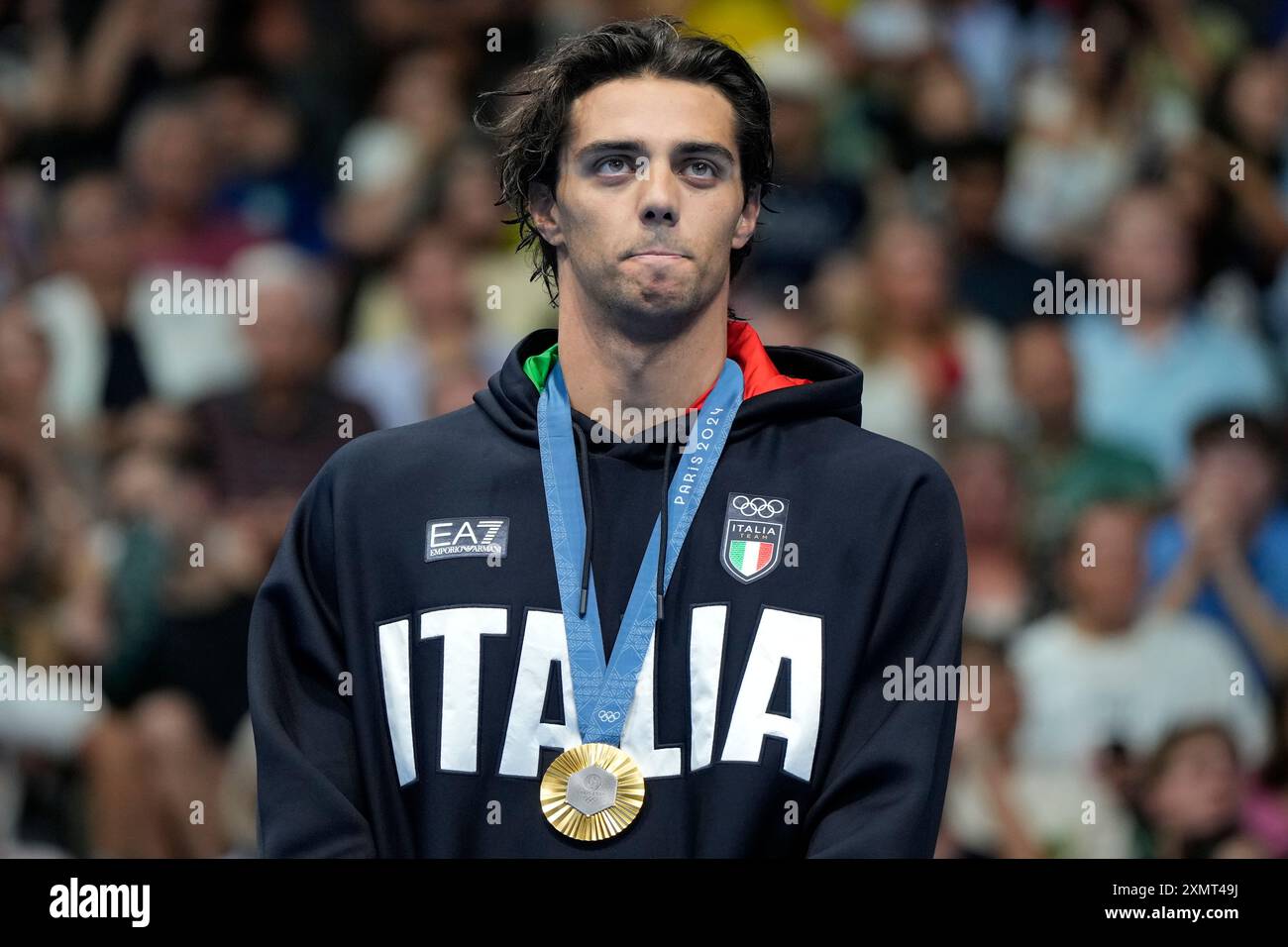 Gold medalist Thomas Ceccon, of Italy, stands on the podium following ...