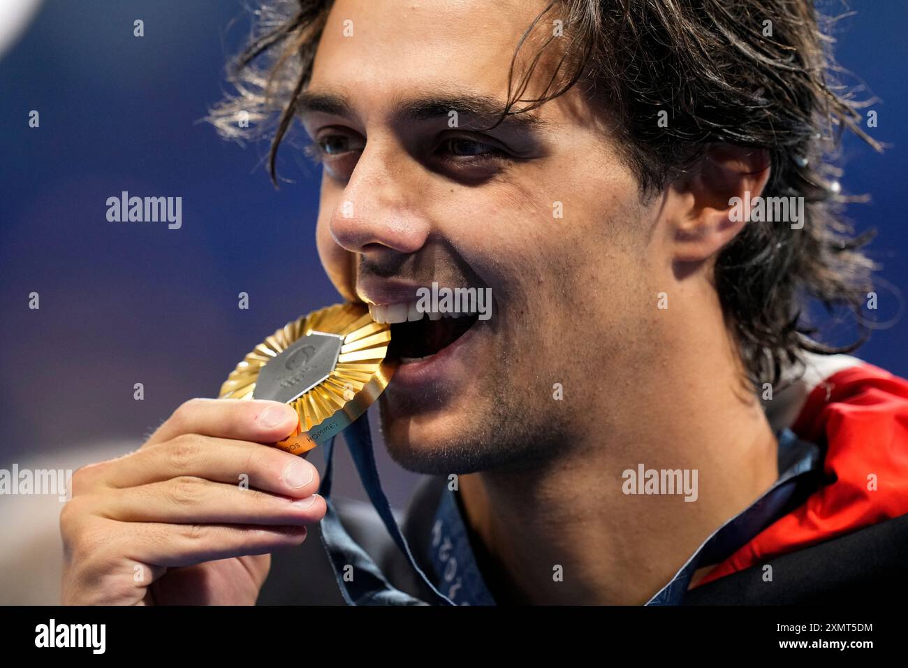 Thomas Ceccon, of Italy, poses with his gold medal after winning men's ...