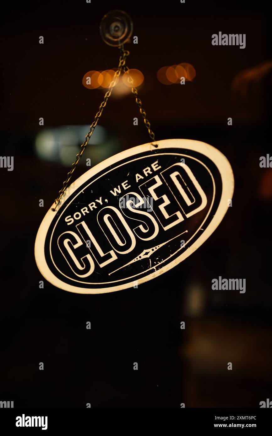 "Sorry, we are closed" sign on shop door at night Stock Photo - Alamy