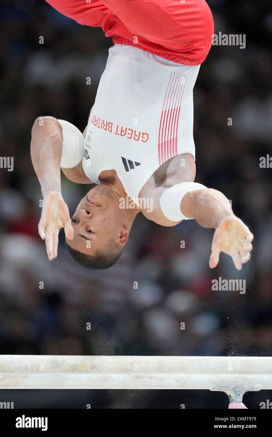 Joe Fraser, of Great Britain, performs on the parallel bars during the ...