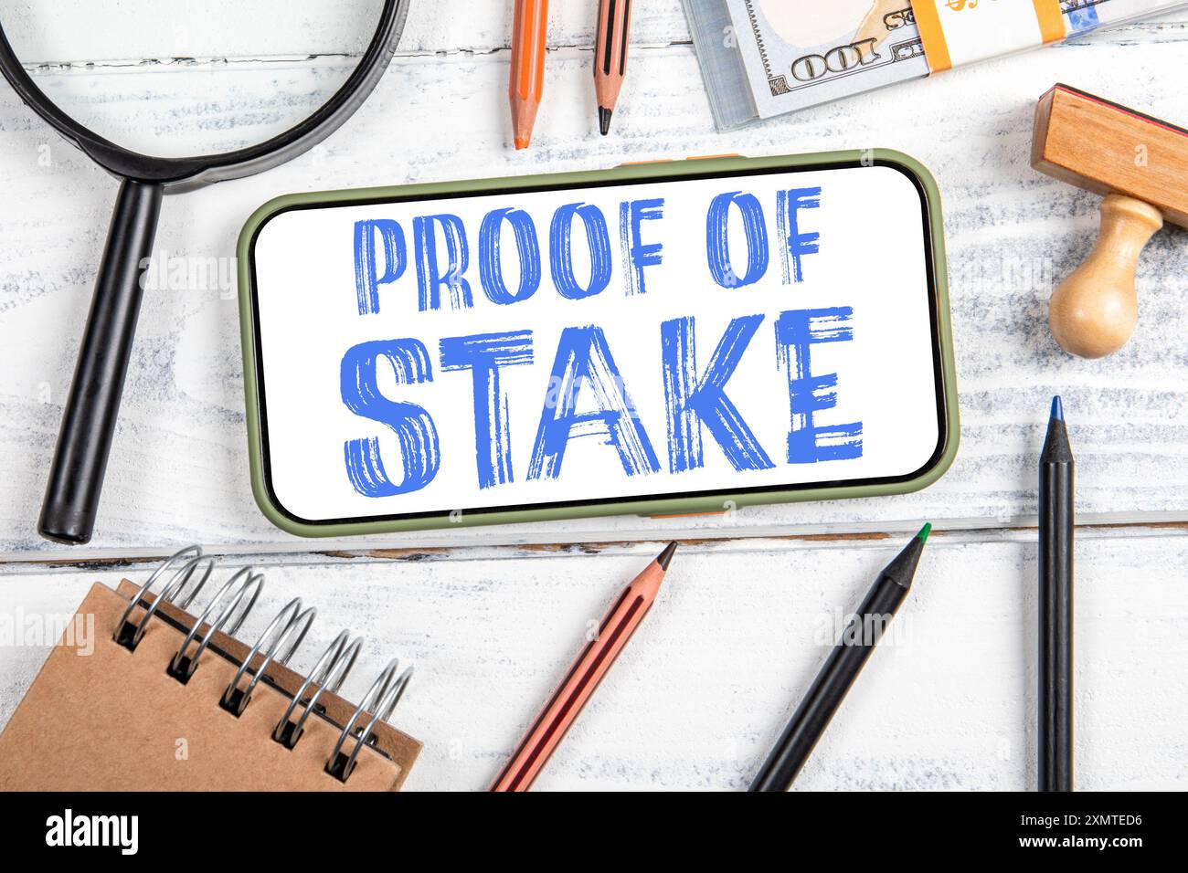 Proof Of Stake. Mobile phone, money and stationery on the office table ...