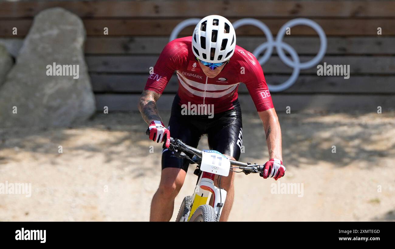 Simon Andreassen, of Denmark, competes in the men's mountain bike race ...