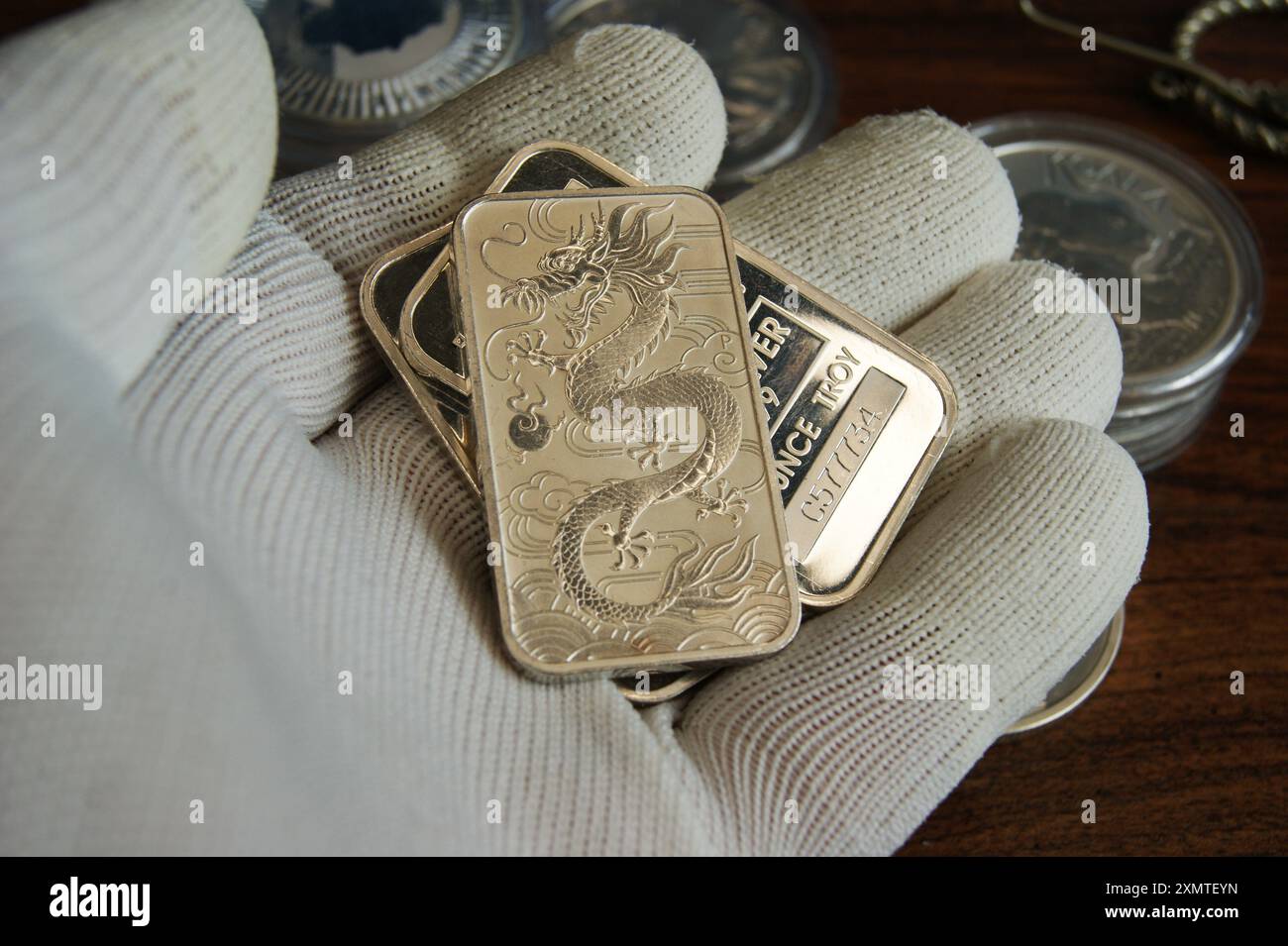 1 oz pure silver bars in assayer's hand. Investments in precious metals ...