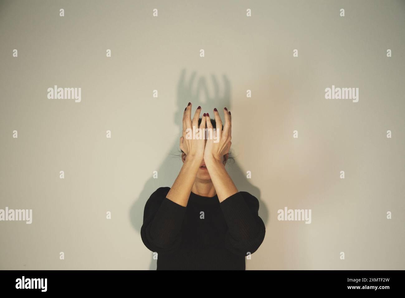 surreal shadow of a crown covers the head of a woman, abstract concept ...