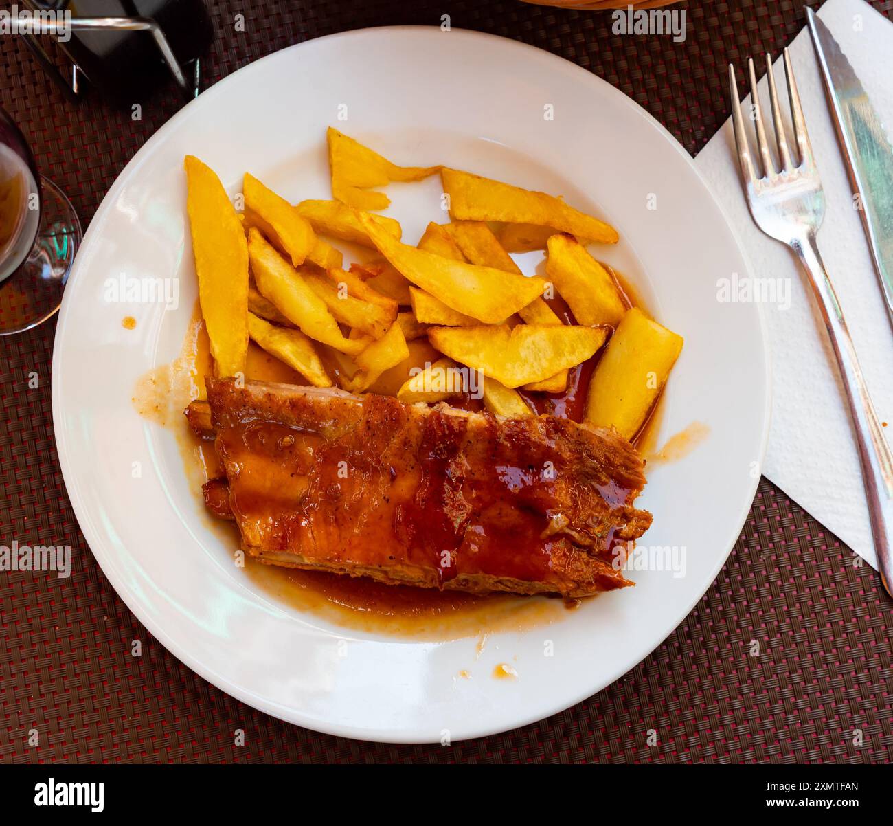 juicy and fatty fried pork ribs with crust, seasoned with coarse sal ...