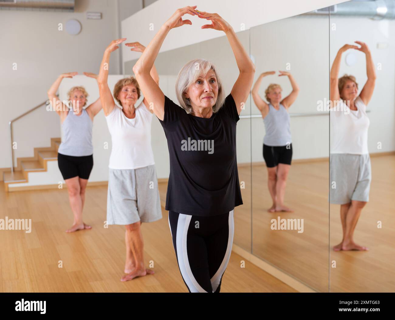 Mature women are standing in the 5th position of the ballet stand Stock ...
