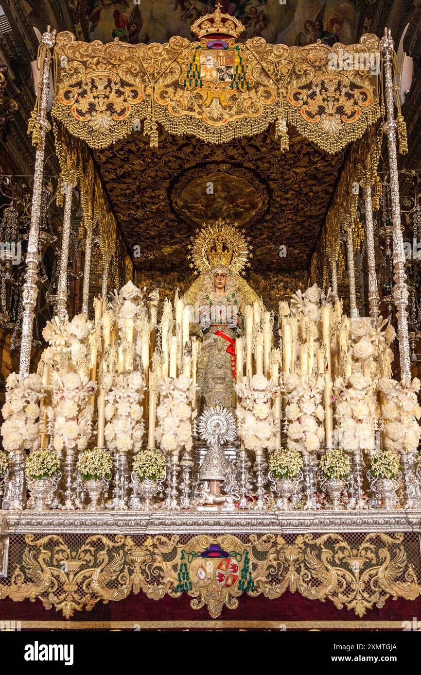 Close up of La Virgen de la Esperanza Macarena with candles after the ...