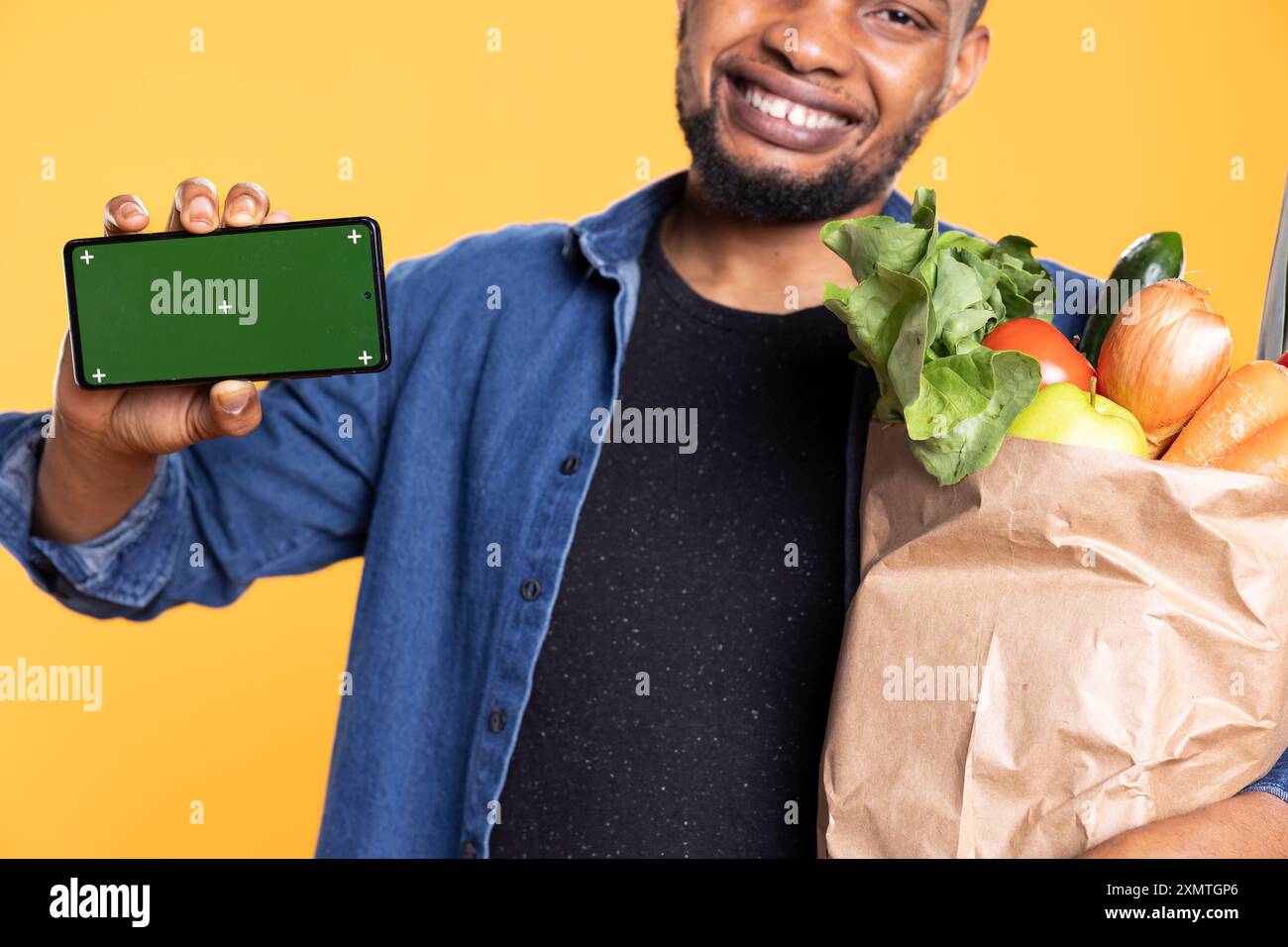 Happy charismatic person showing greenscreen display on camera ...