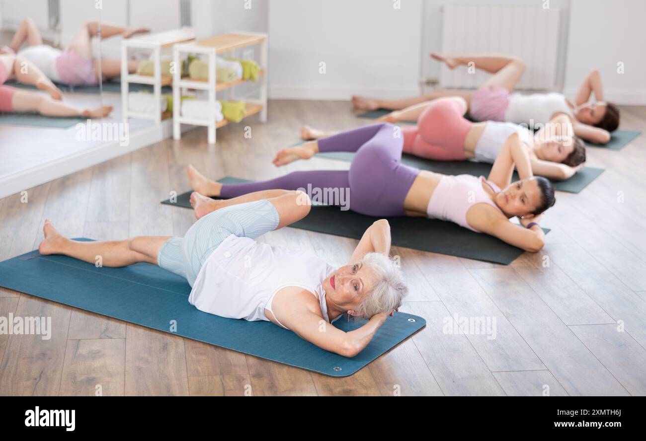 Woman performing supta matsyendrasana spinal hi-res stock photography ...