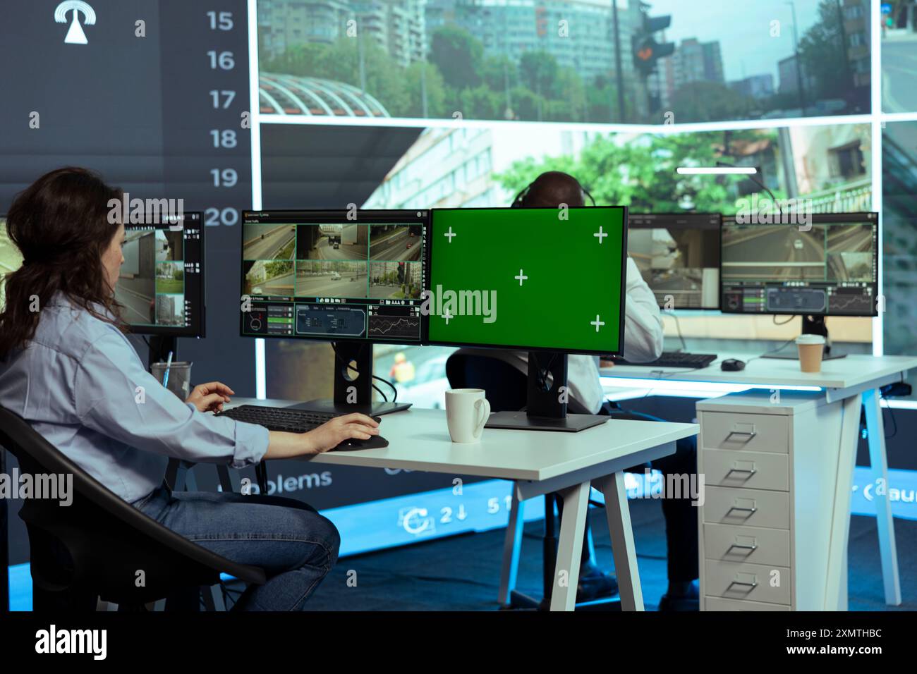 Operator monitors traffic next to an isolated mockup display, following ...