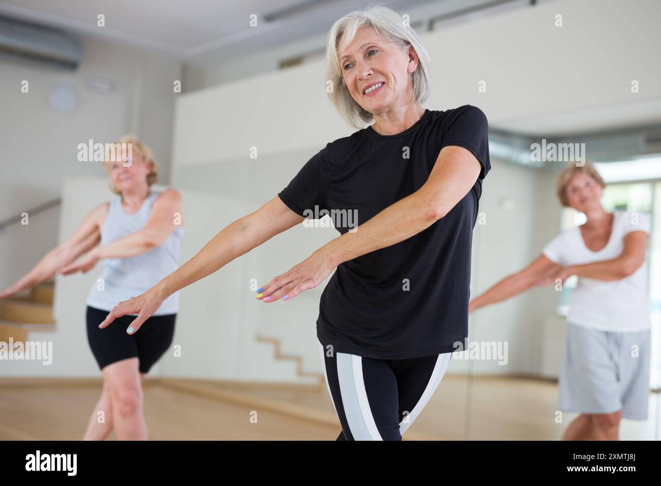Positive aged woman practicing vigorous dance movements Stock Photo - Alamy