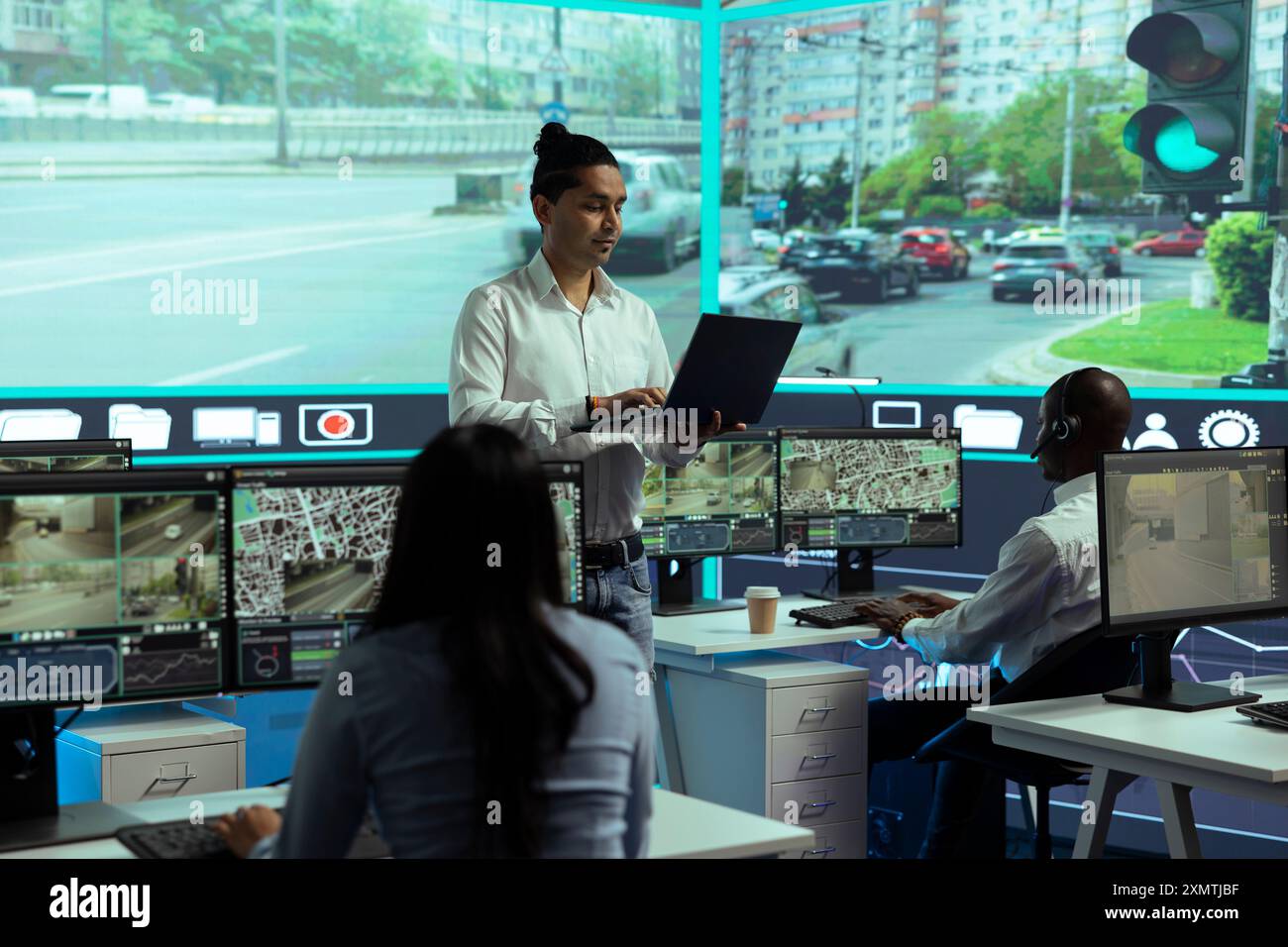Indian team leader coordinating his employees to monitor urban ...