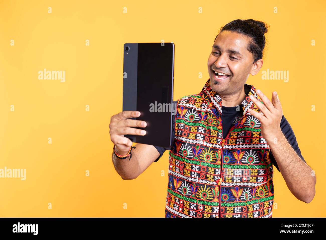 Joyous man having positive mood using tablet to take selfies from all ...