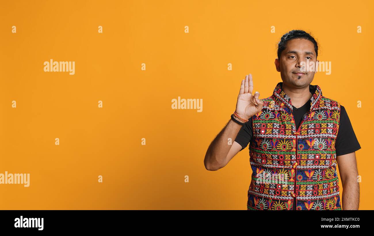 Indian man doing ok hand sign, feeling pleased, agreeing with ...
