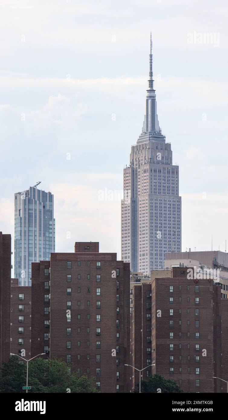 view of nyc skyline with empire state building above brick residential apartment buildings Stock ...