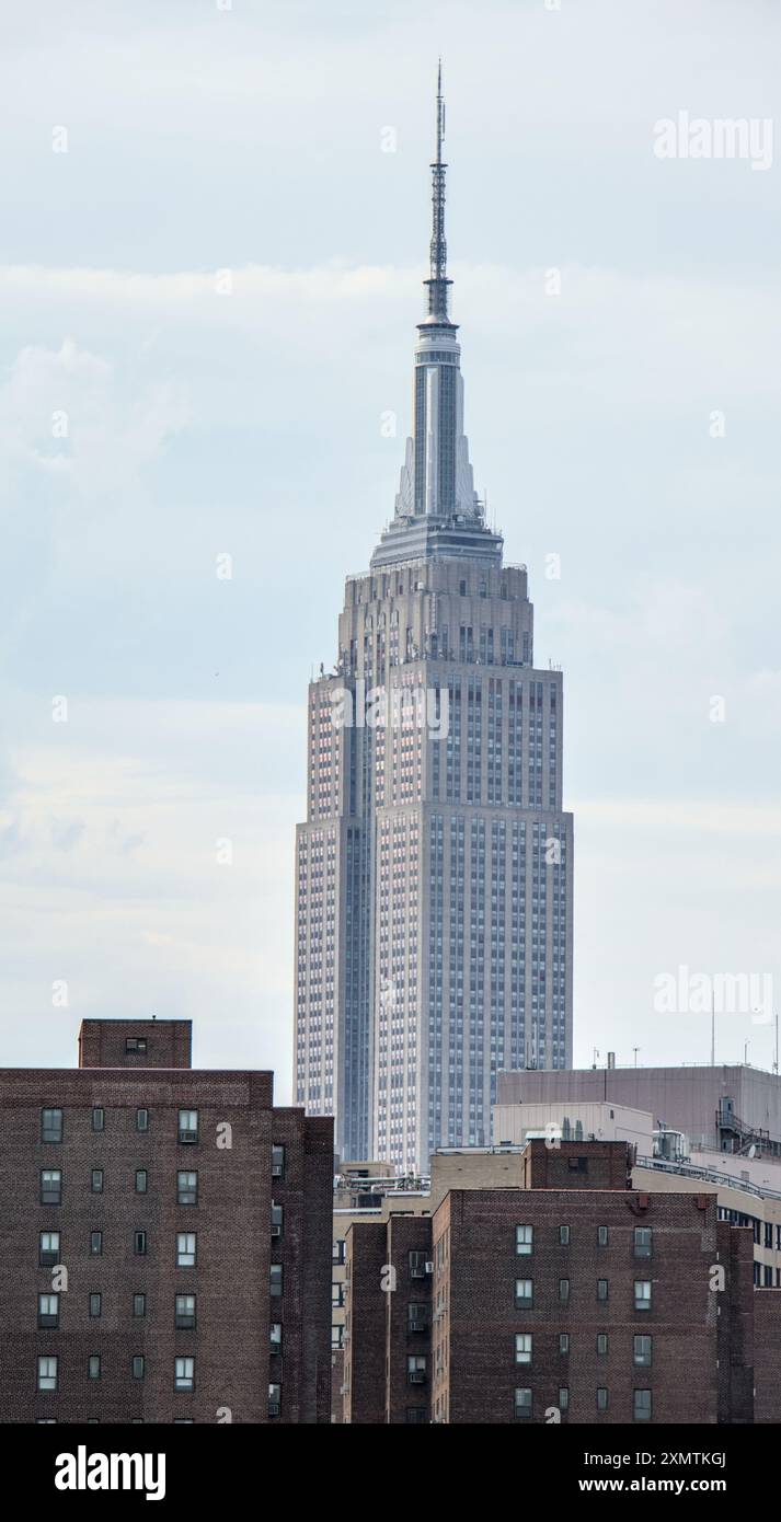 view of nyc skyline with empire state building above brick residential apartment buildings Stock ...