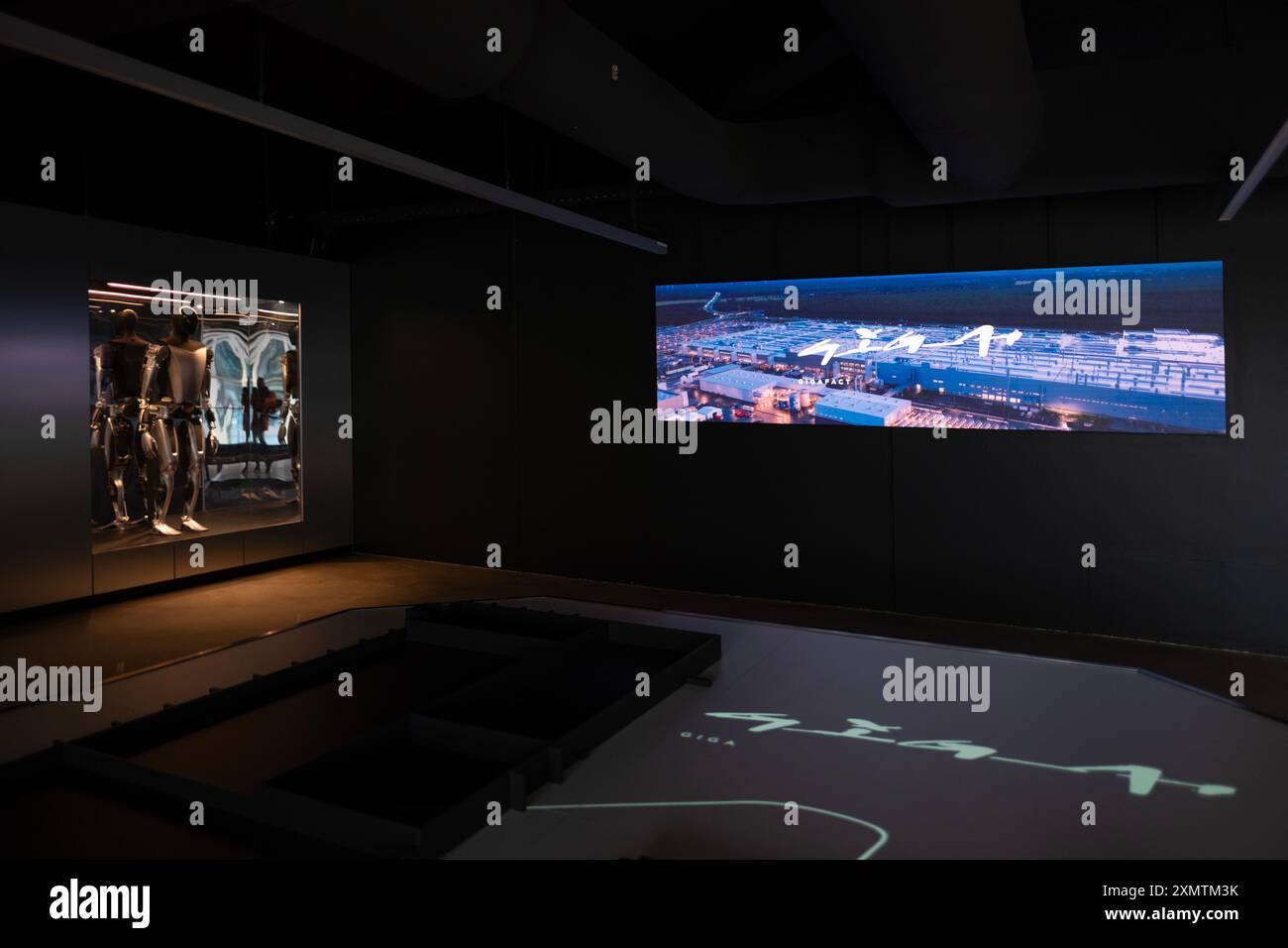 Tesla Bot Optimus robotic humanoid in Tesla's Giga Berlin lobby, large ...