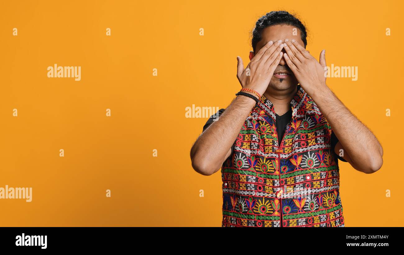 Indian man covering eyes, ears and mouth with hands, imitating the ...