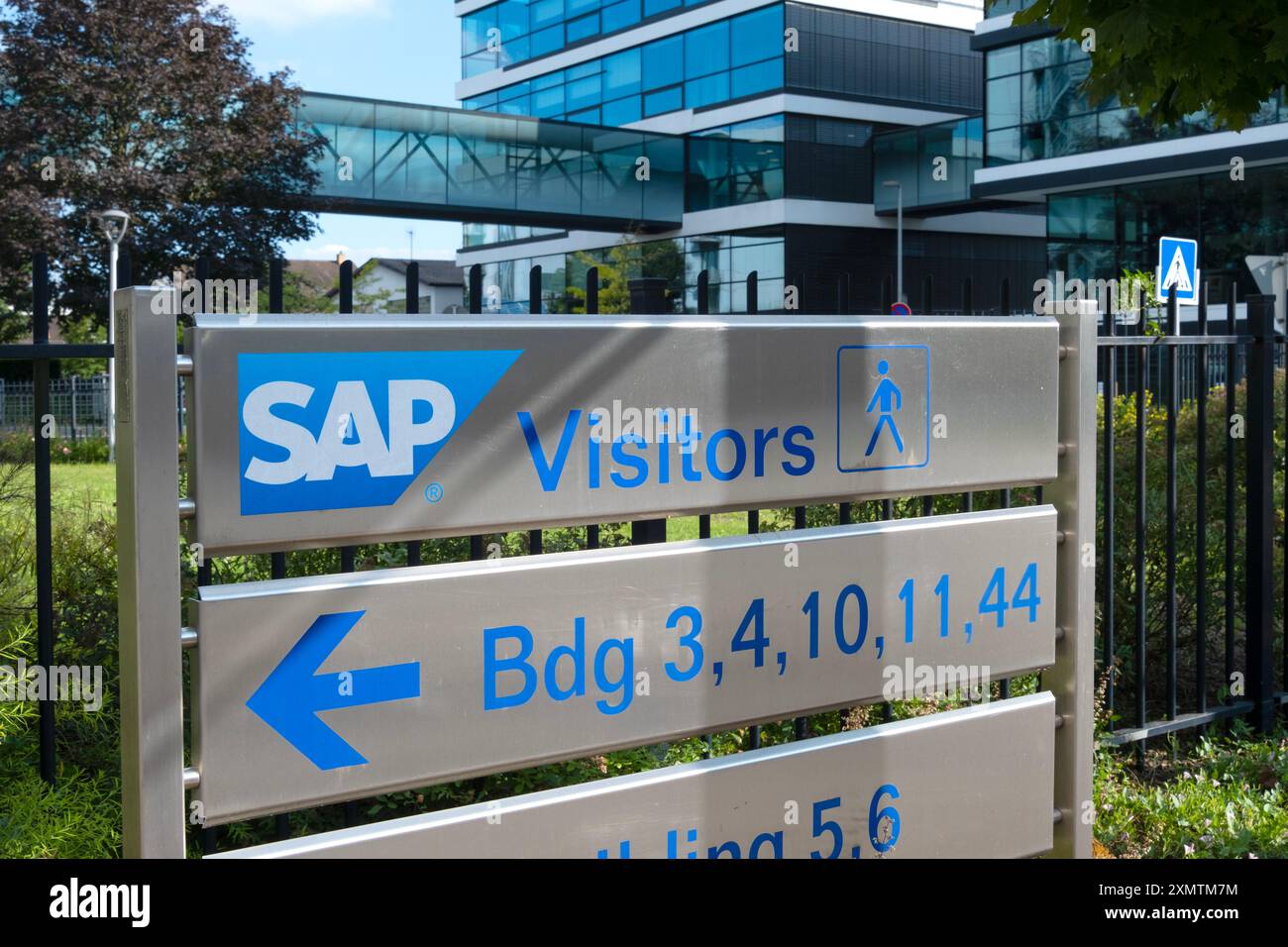 SAP SE logo prominently displayed on modern corporate headquarters facade, SAP corporate campus ...