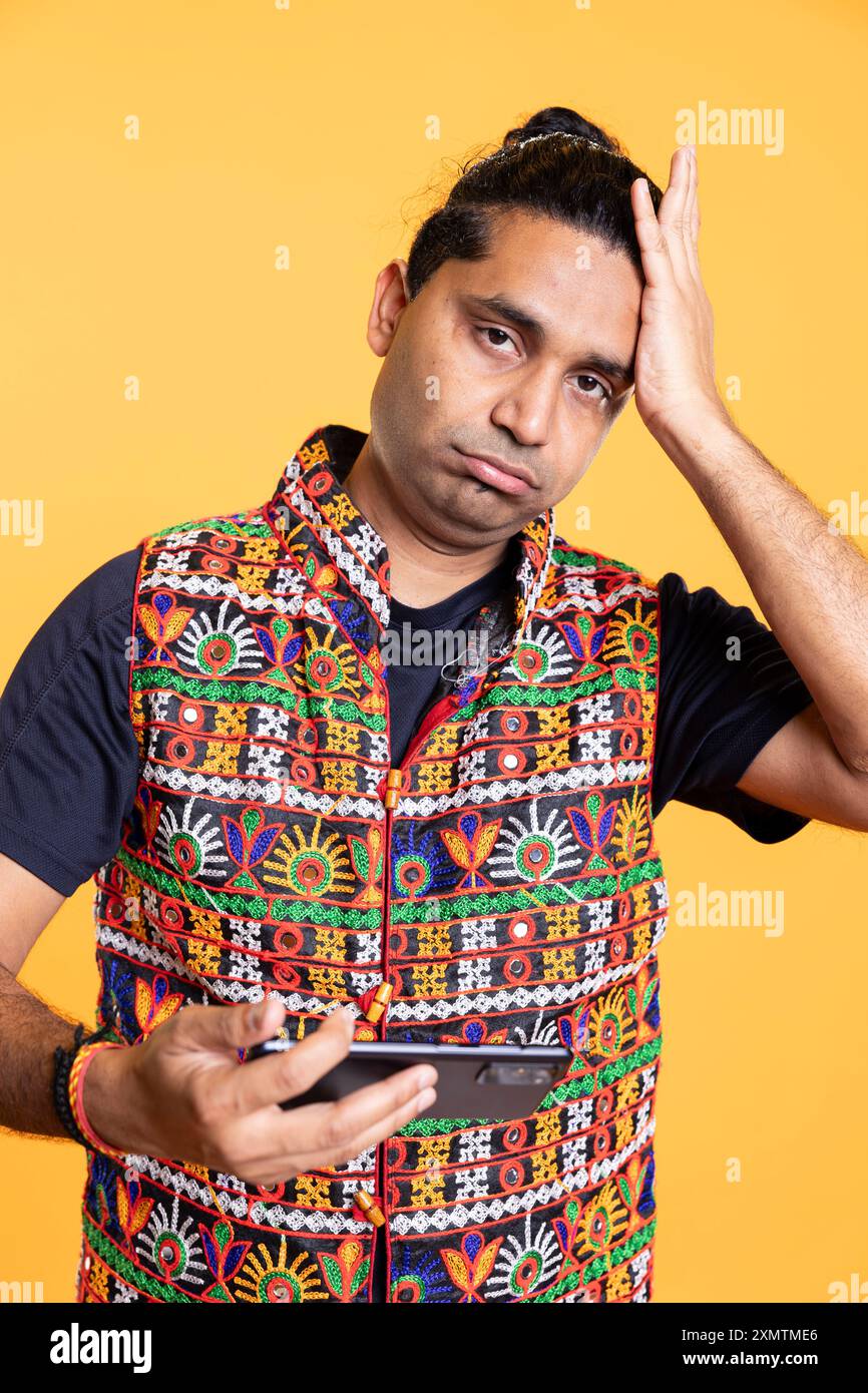 Gamer playing online multiplayer videogame on smartphone, annoyed after ...