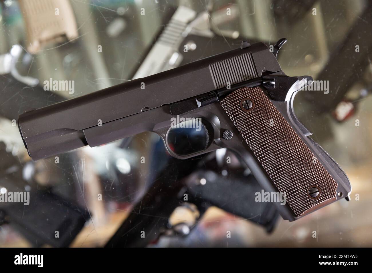 Pistol on showcase in weapon shop Stock Photo - Alamy