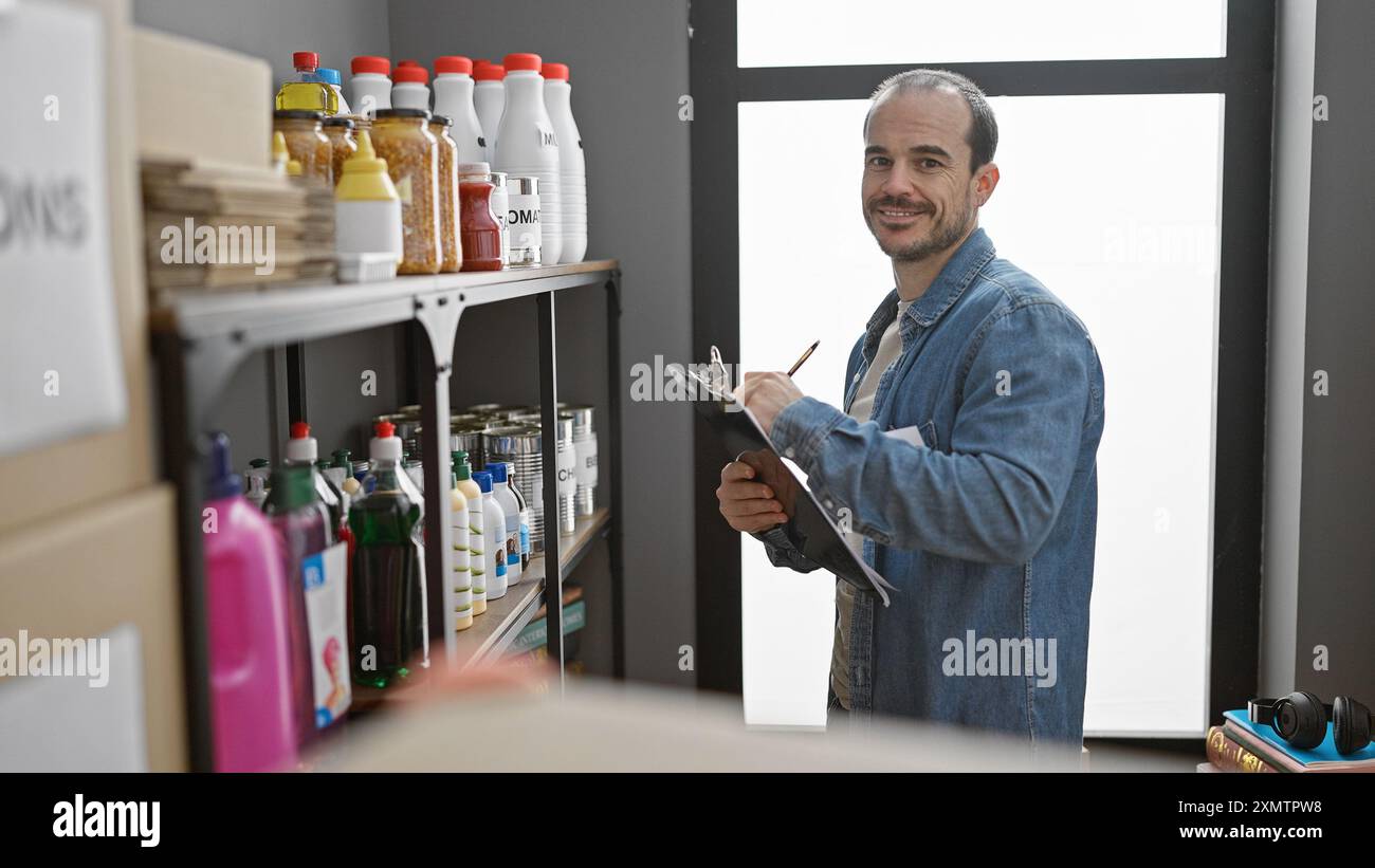 Bearded man inventorying donations in a well-organized warehouse ...