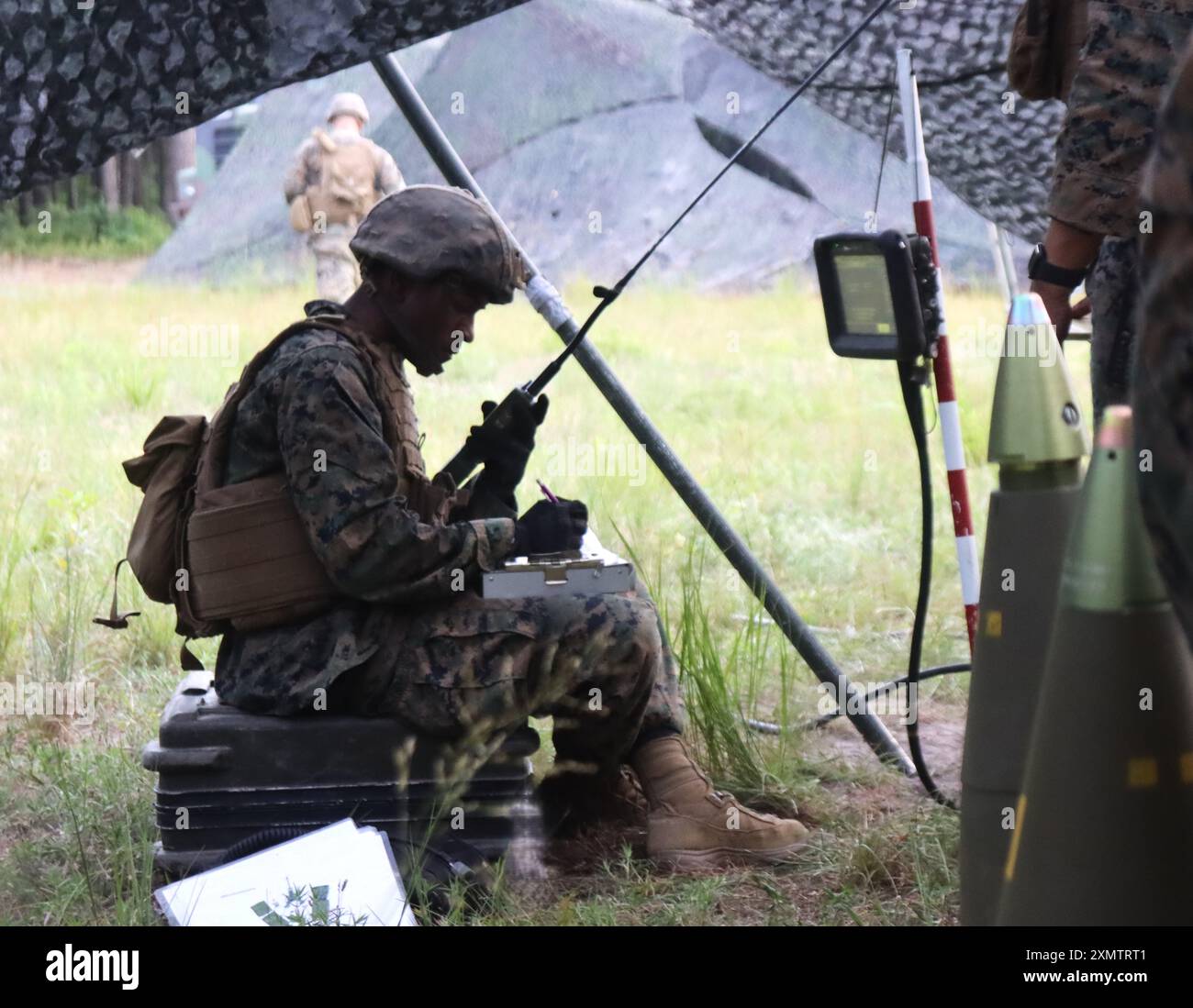 A radio operator from Golf Battery of the 3rd BN, 14 USMC, receives ...