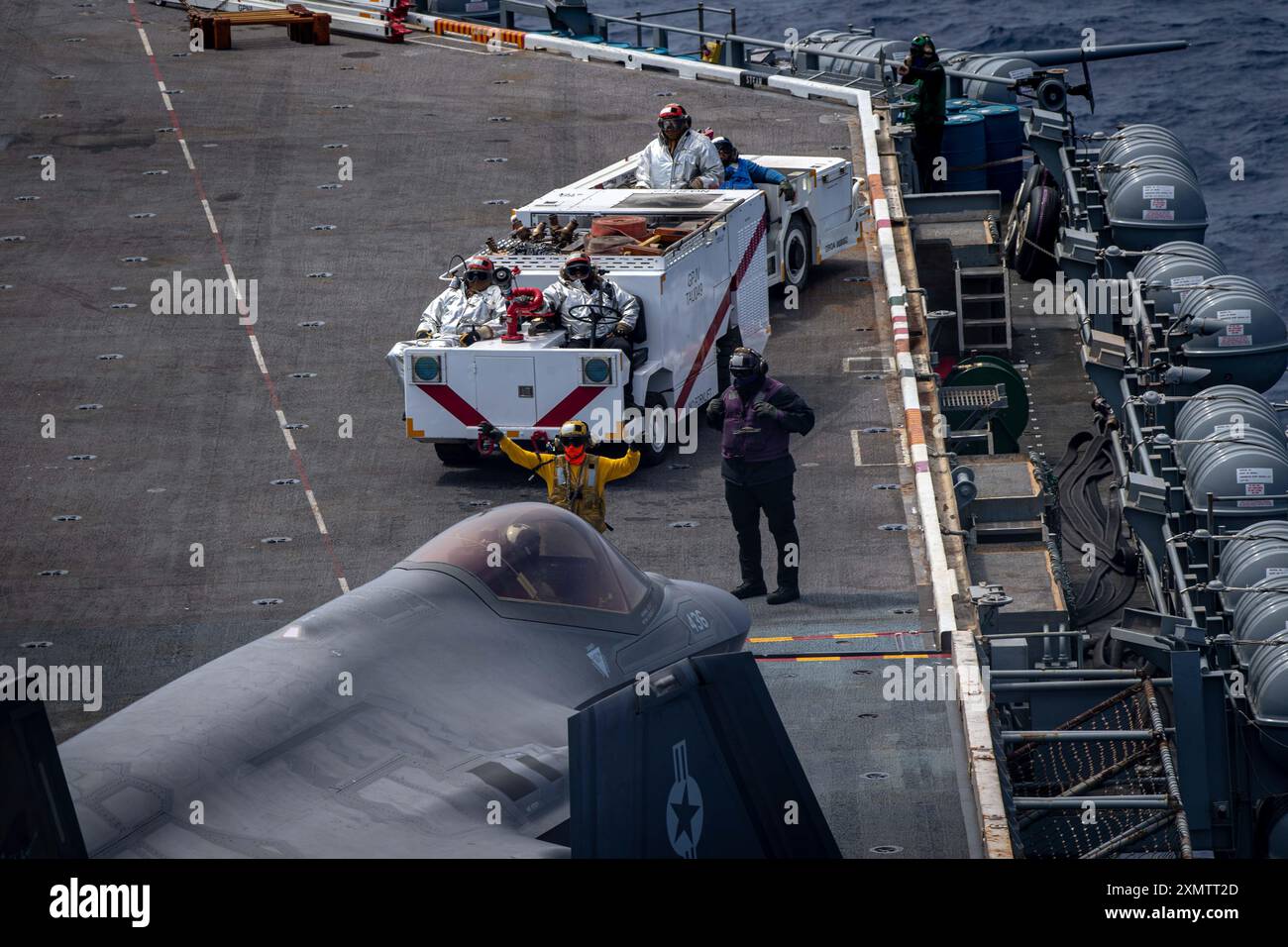 A Sailor directs an F-35C Lightning II from the "Rough Raiders" of ...