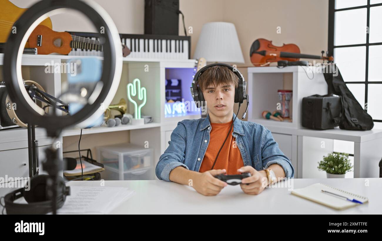A focused young man plays video games wearing headphones in a modern ...
