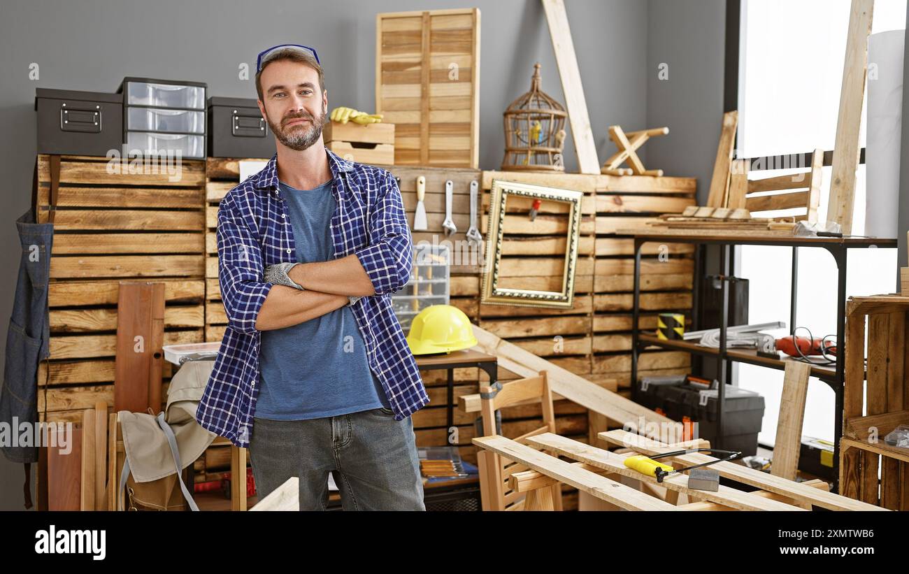 Confident carpenter stands arms crossed in a well-organized woodworking ...