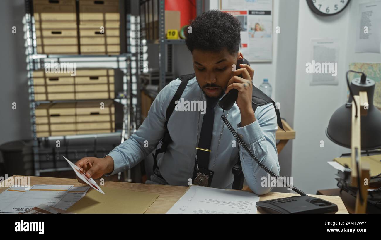 African american detective analyzes evidence at his desk while talking ...