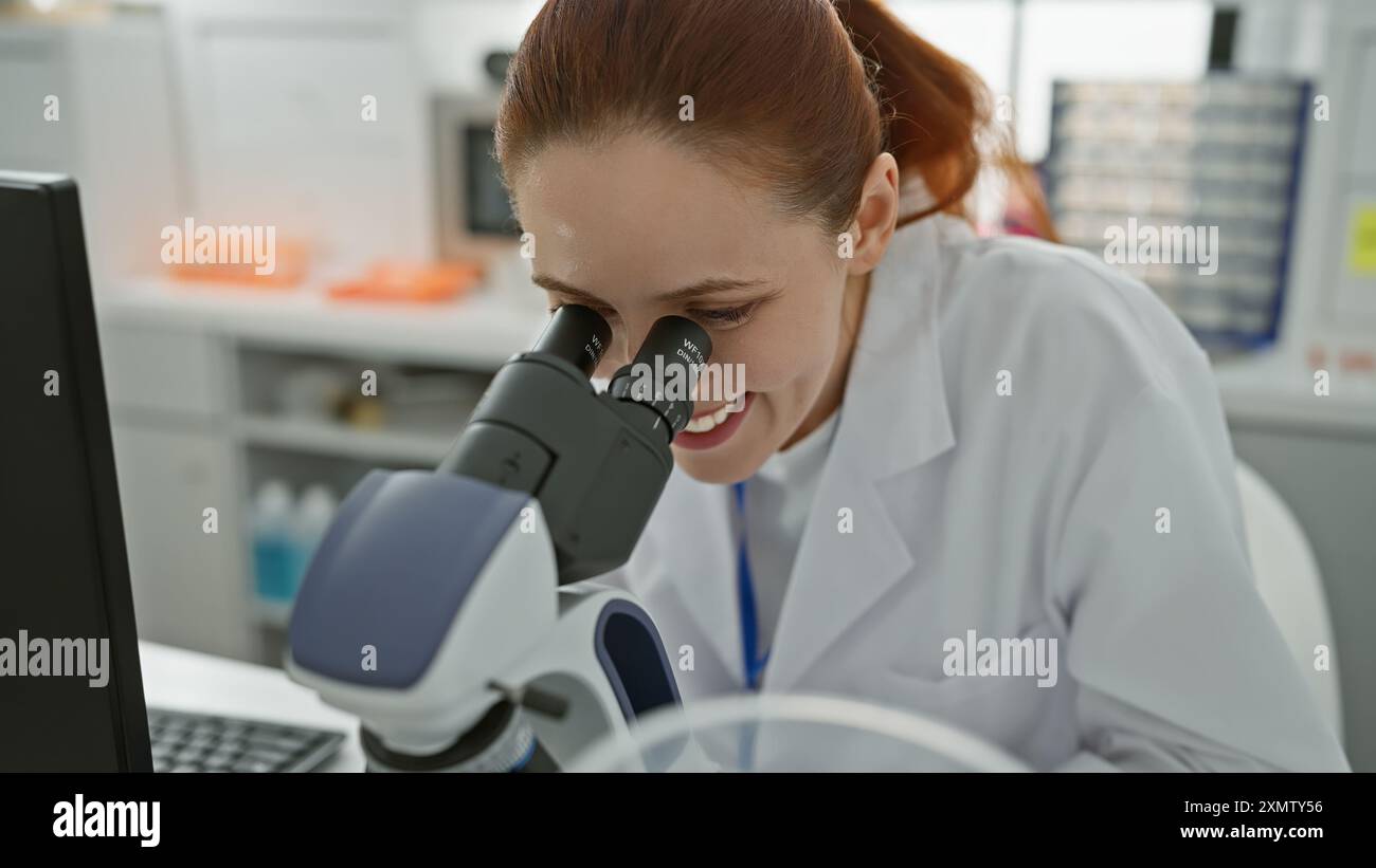 Smiling woman scientist using microscope hi-res stock photography and ...
