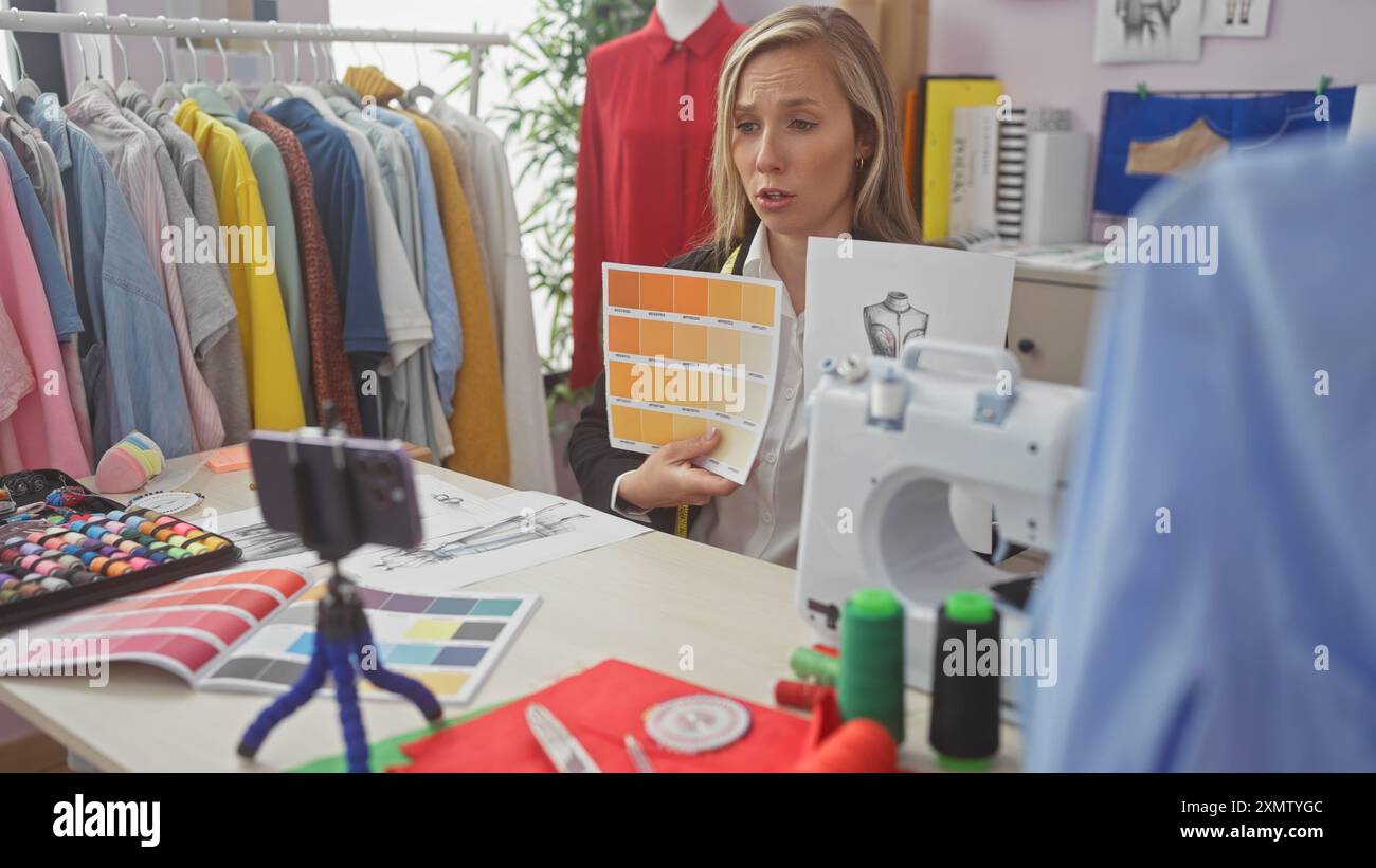 A woman examines color swatches in a tailor shop with clothes, a sewing ...