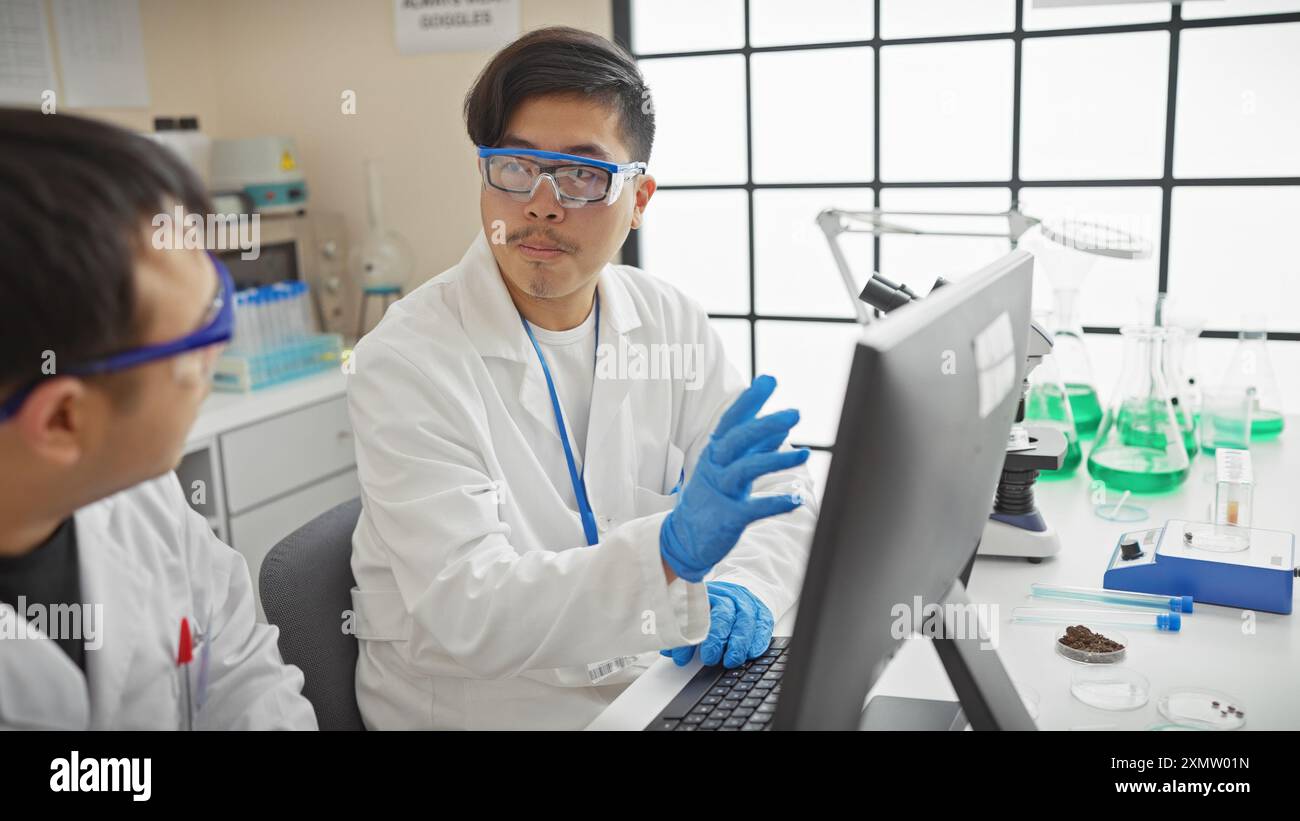 Laboratory with vials and scientists hi-res stock photography and ...