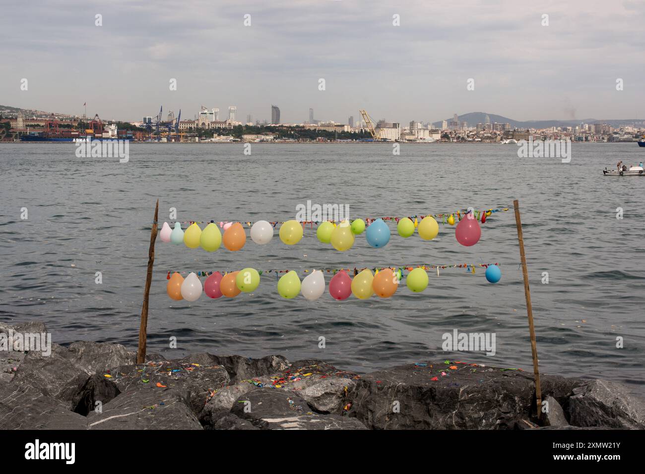 Balloon shooting game with balloons tied on a string Stock Photo - Alamy
