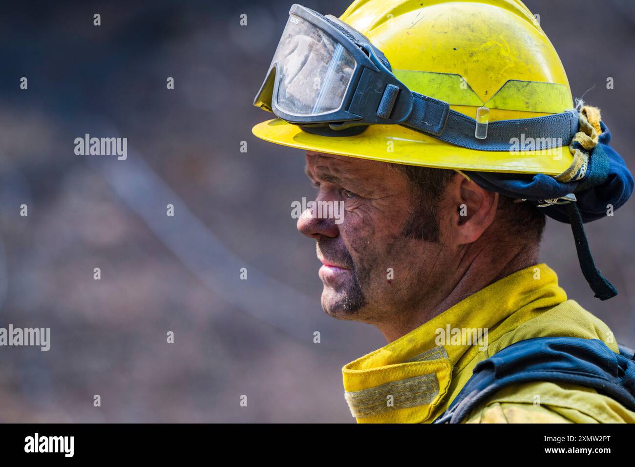 A firefighter takes a break as the Park Fire burns near Butte Meadows ...