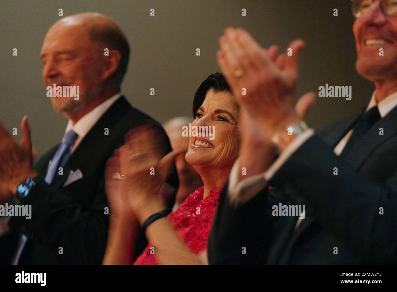 Attendees at President Joe Biden's address applaud as he takes the ...