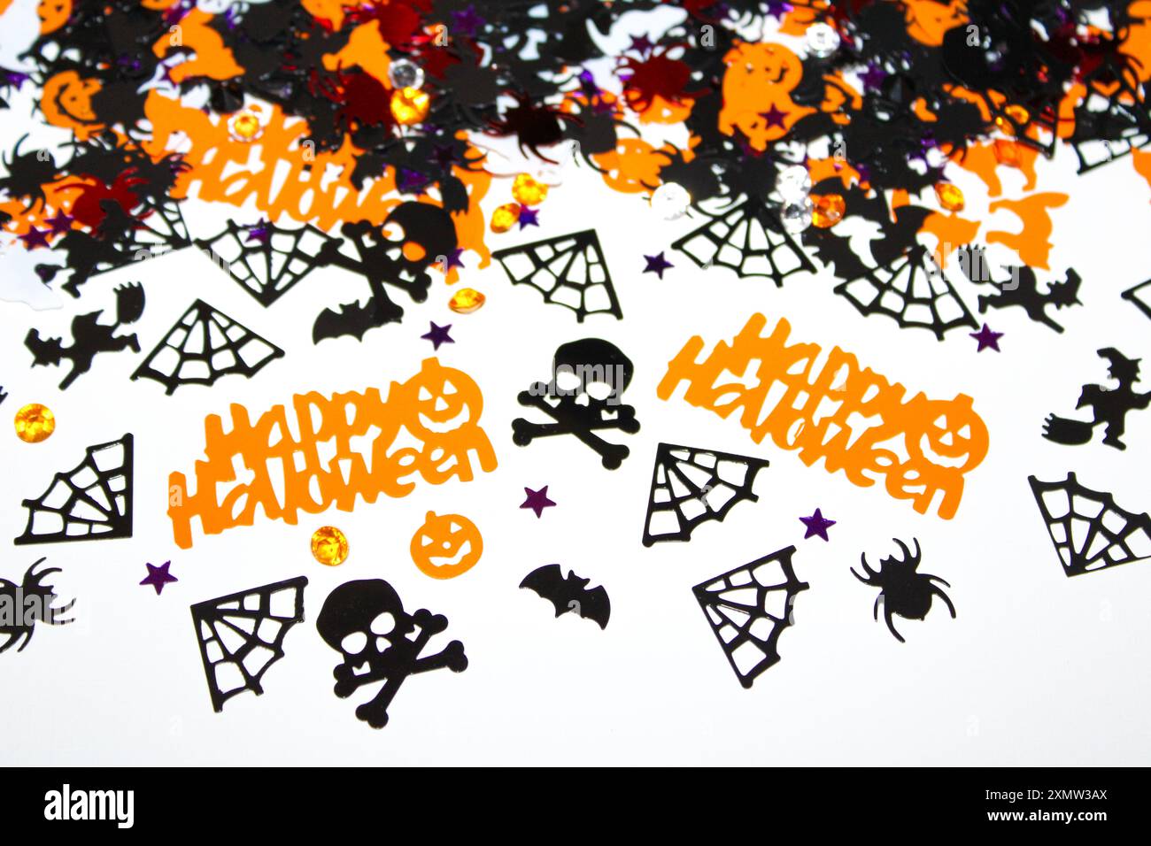 Halloween confetti with skulls, spider webs, bats, cats, witches, and ...