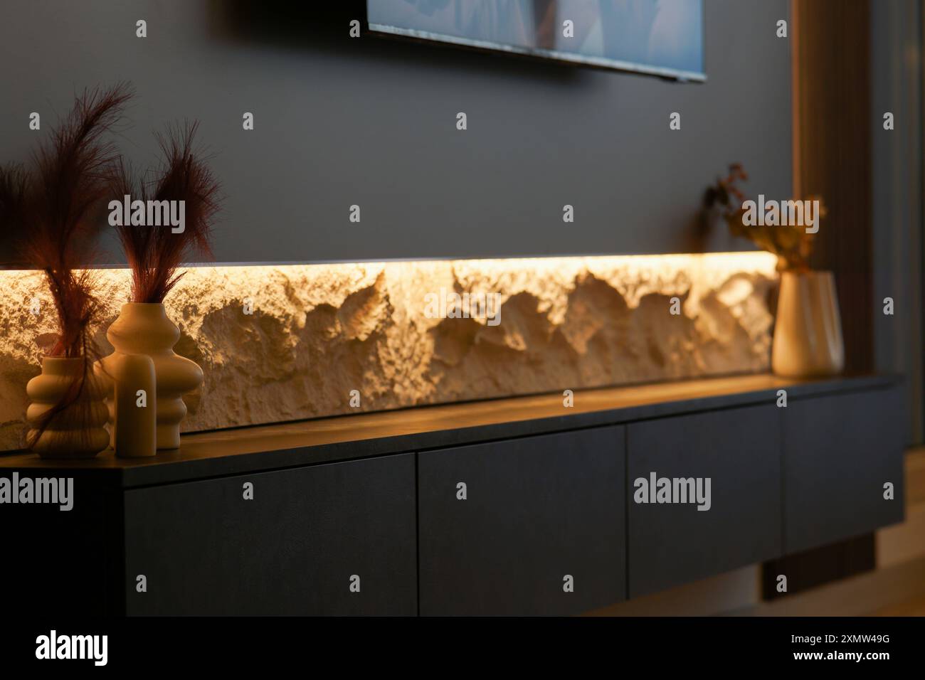 modern floating TV media console dark room ambient LED light Stock ...