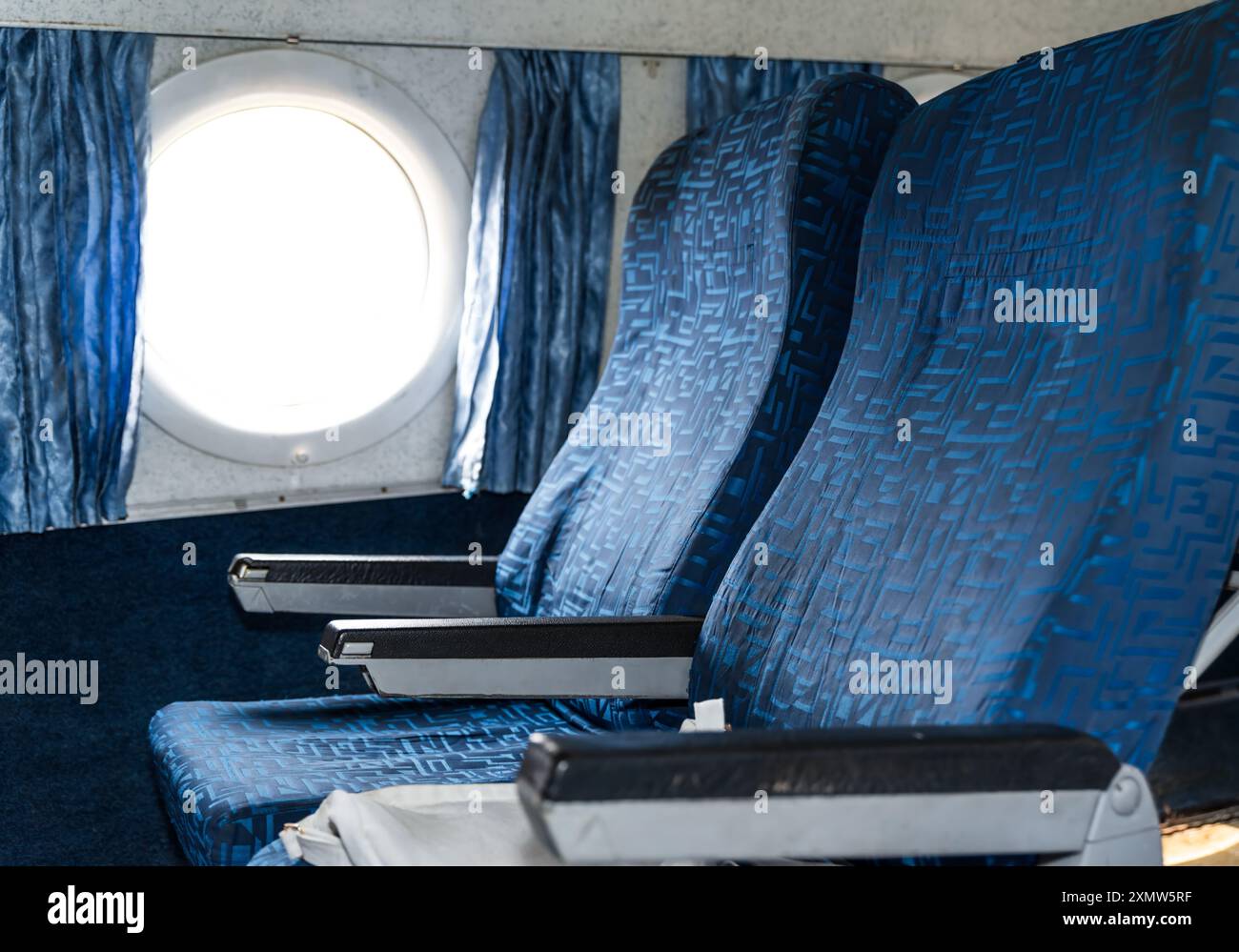 Two empty airplane seat seats and window in a passenger airplane close ...