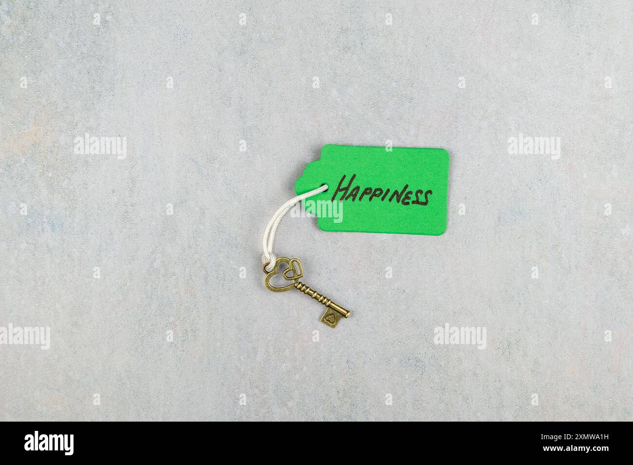Key with tag - key to happiness concept Stock Photo - Alamy