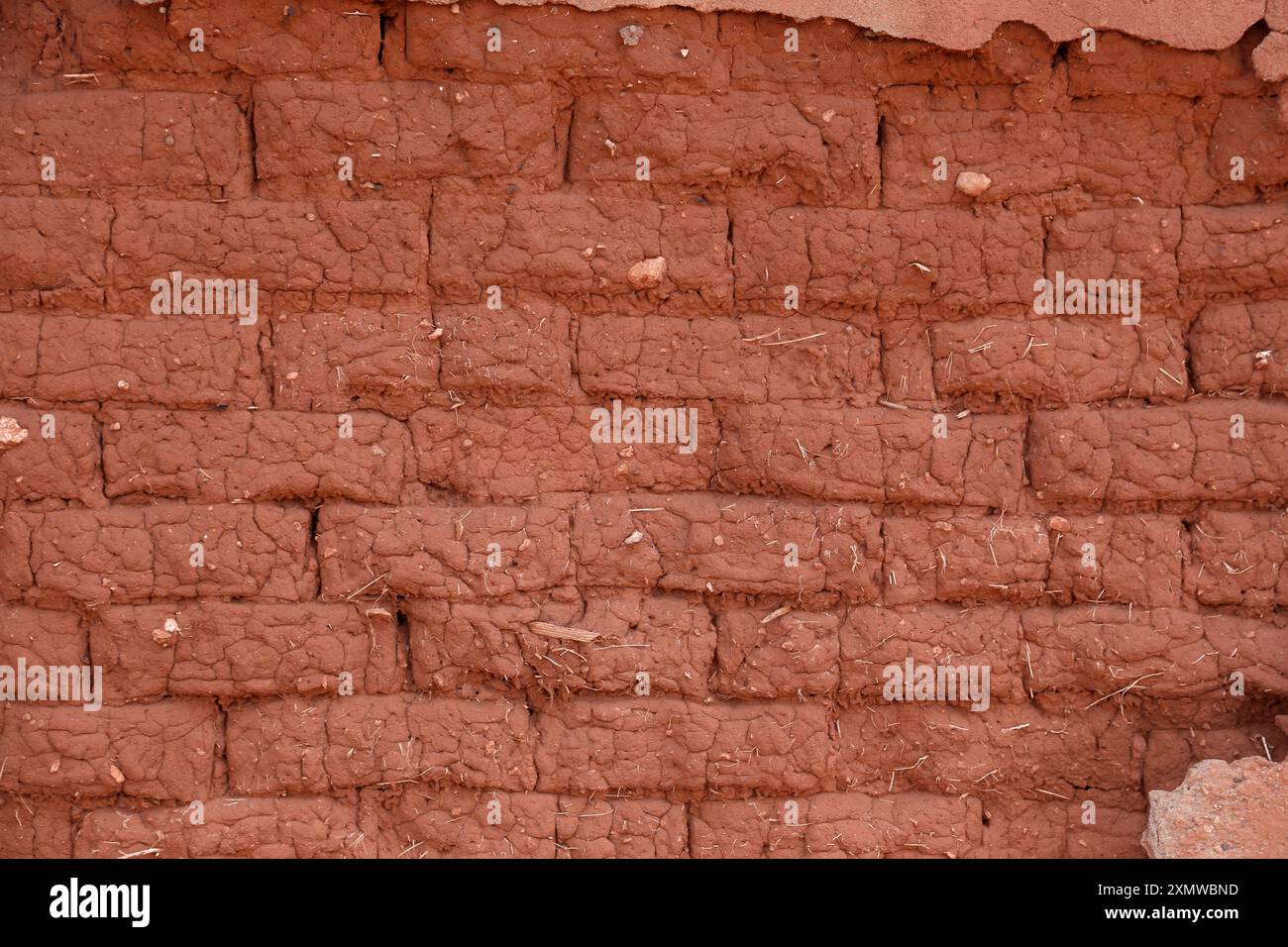 Texture of traditional adobe wall construction revealed on the side of a New Mexico old building ...