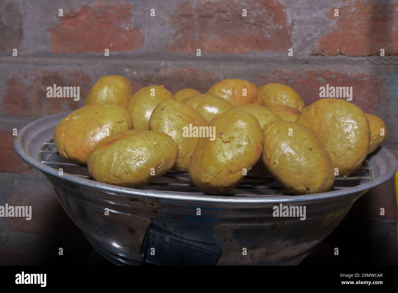 baking Bati on oven, close-up of Rajasthani Indian dish, wheat flour ...