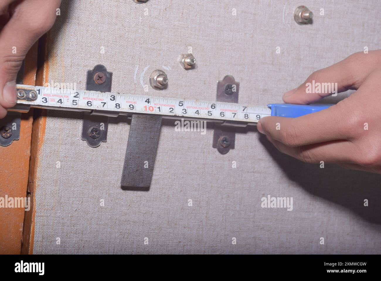 door handle measurement, man measuring the door with a tape measure ...
